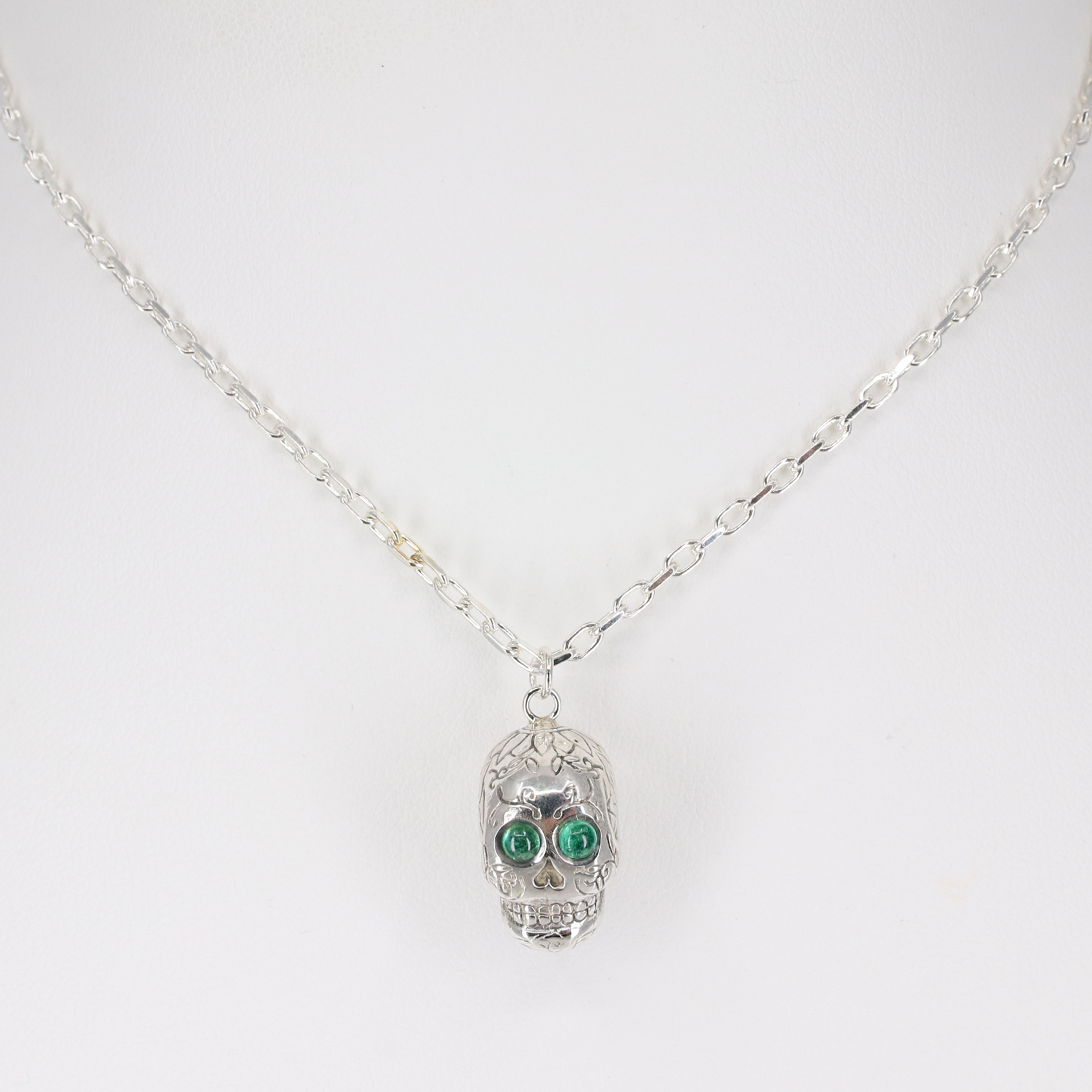 Silver sugar skull pendant set with cabachon emeralds - Baroque Jewellery