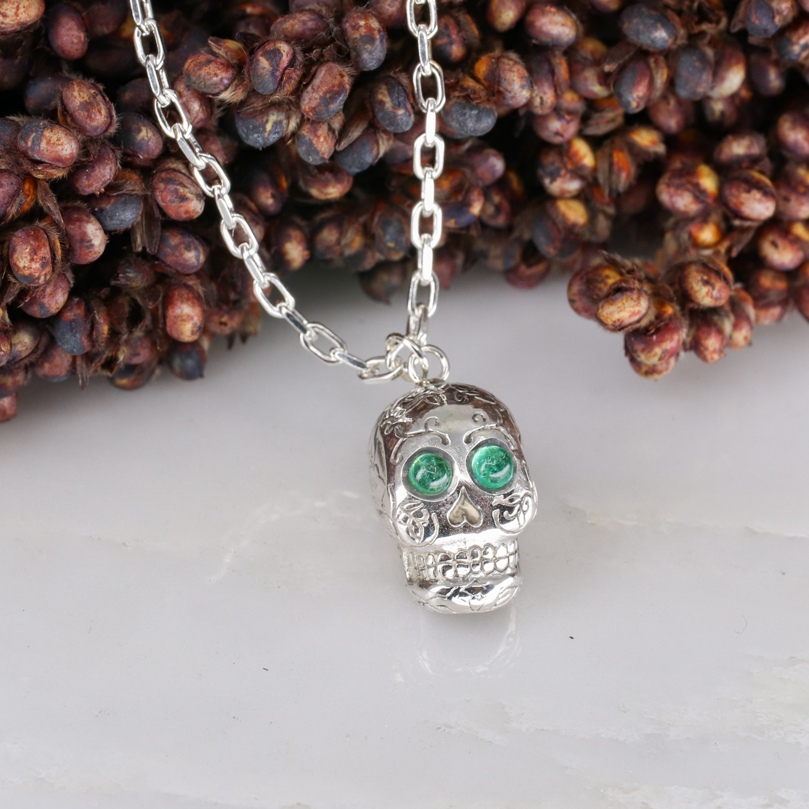 Silver sugar skull pendant set with cabachon emeralds - Baroque Jewellery