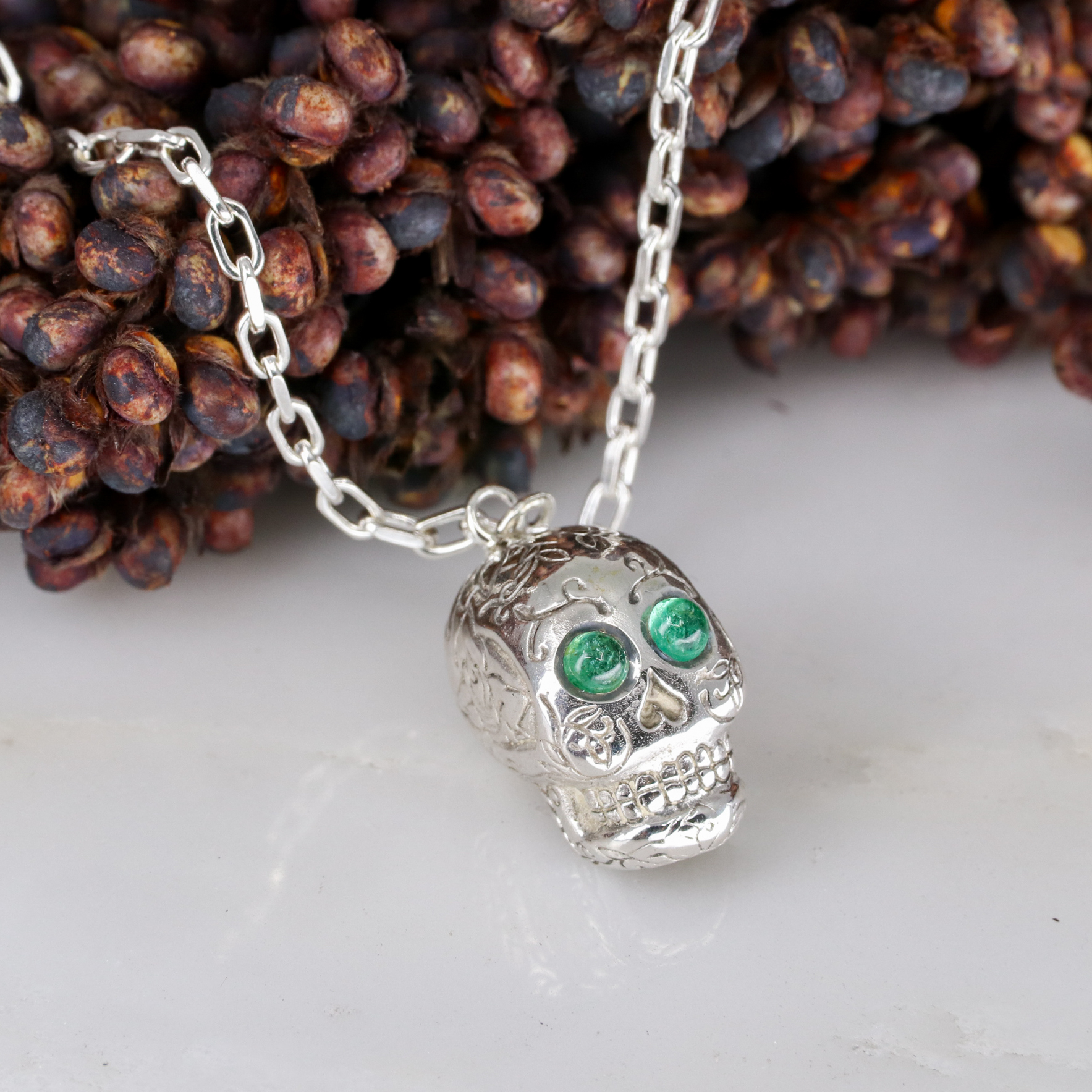 Silver sugar skull pendant set with cabachon emeralds - Baroque Jewellery
