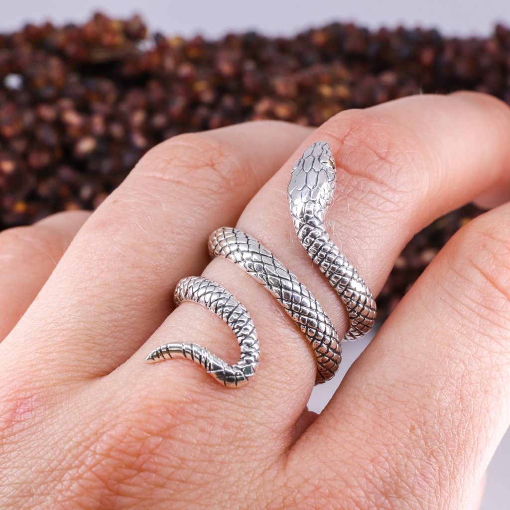 Silver coiled snake ring with orange diamond eyes - Baroque Jewellery