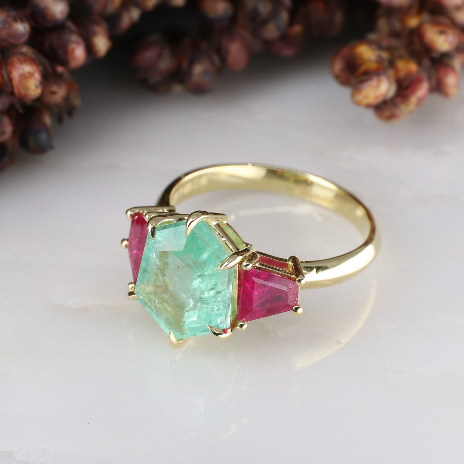 18ct yellow gold trilogy ring with hexagon pale green beryl centre and ...